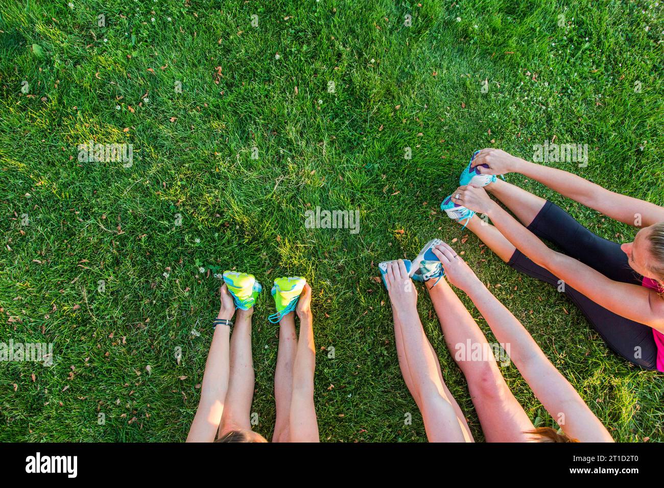 Women stretching legs on grass hi-res stock photography and images - Alamy