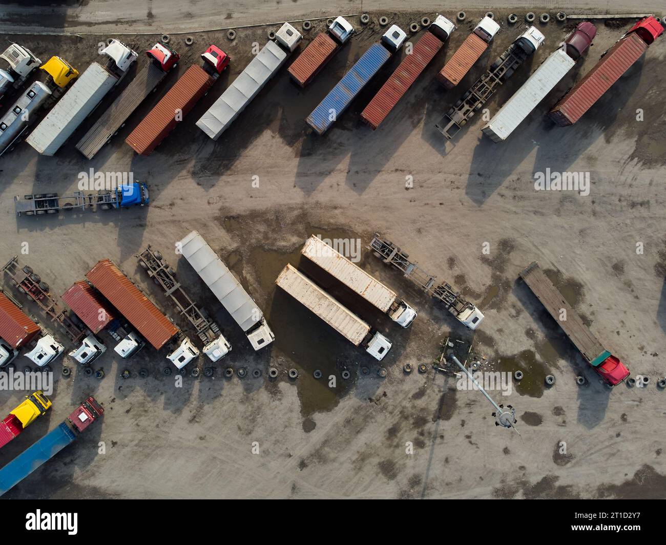 aerial view of a parking lot of trucks ready for loading containers and ...