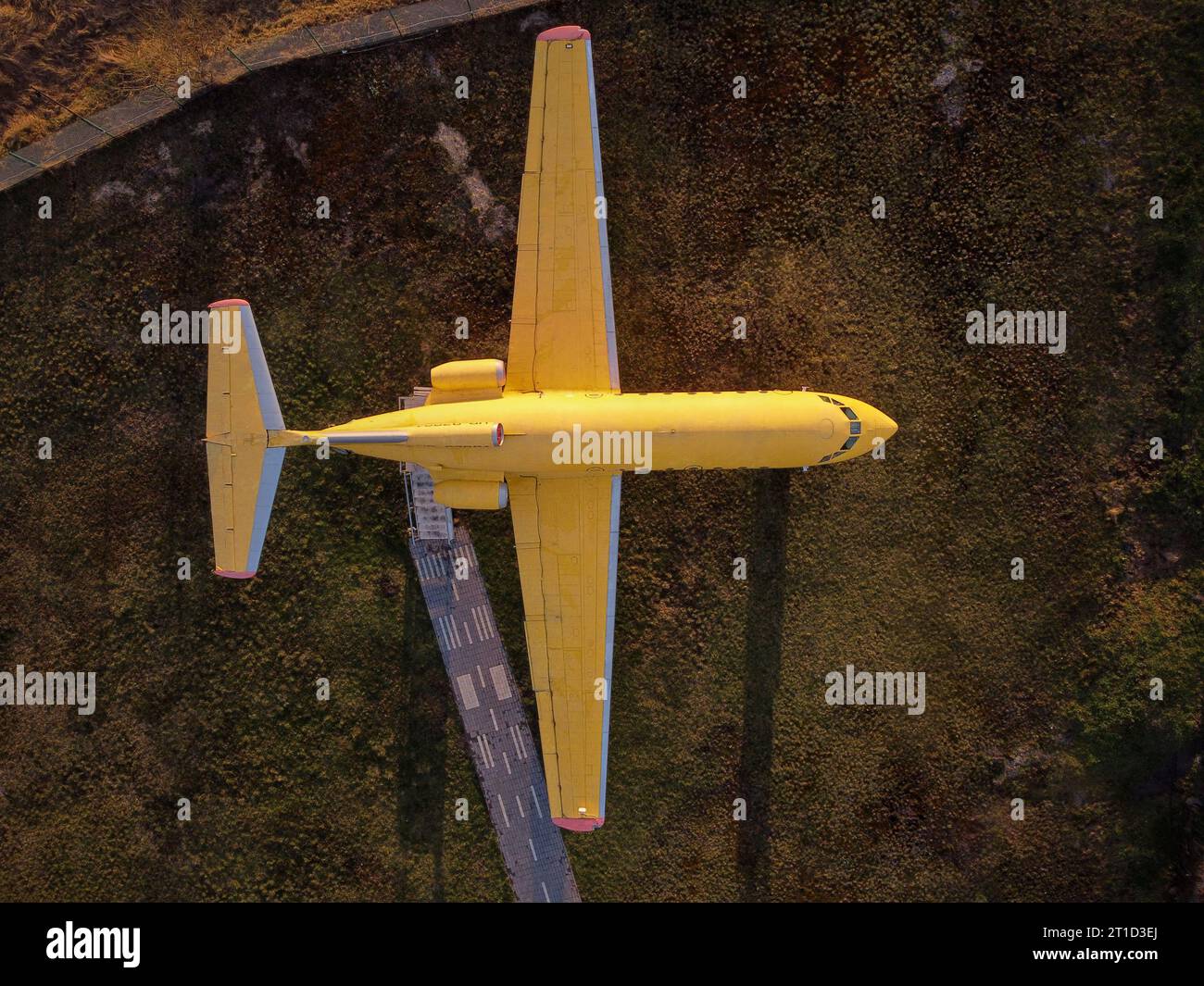 aerial view from drone of a small old jet yellow passenger plane ...