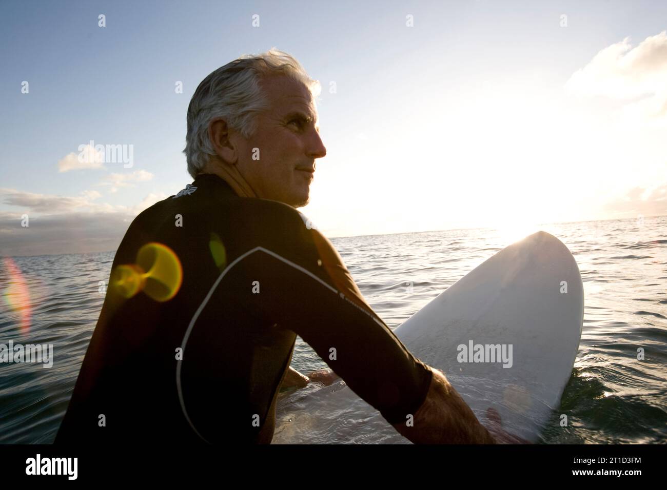 a profile of a senior surfer on his surfboard Stock Photo - Alamy