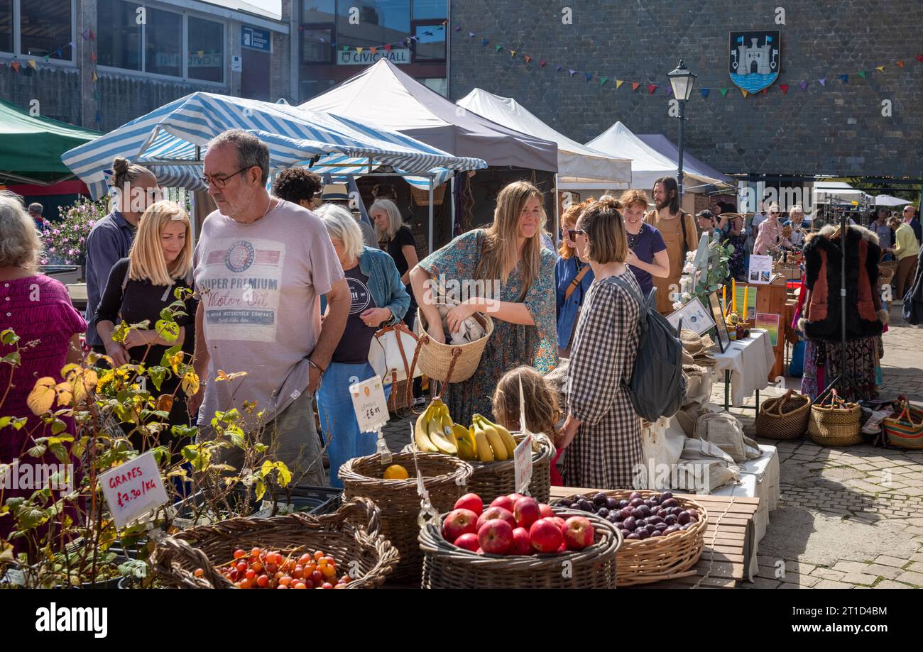 People browse food and clothing stalls in the traditional market in the ...