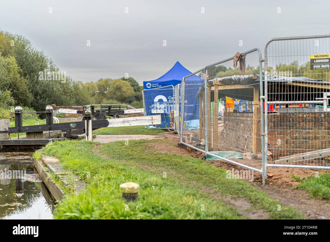 Canal and River Trust working at a lock on a canal repairing a ...