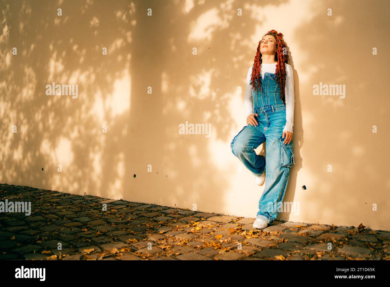 Young woman relaxing near a shady wall in Prague Stock Photo - Alamy
