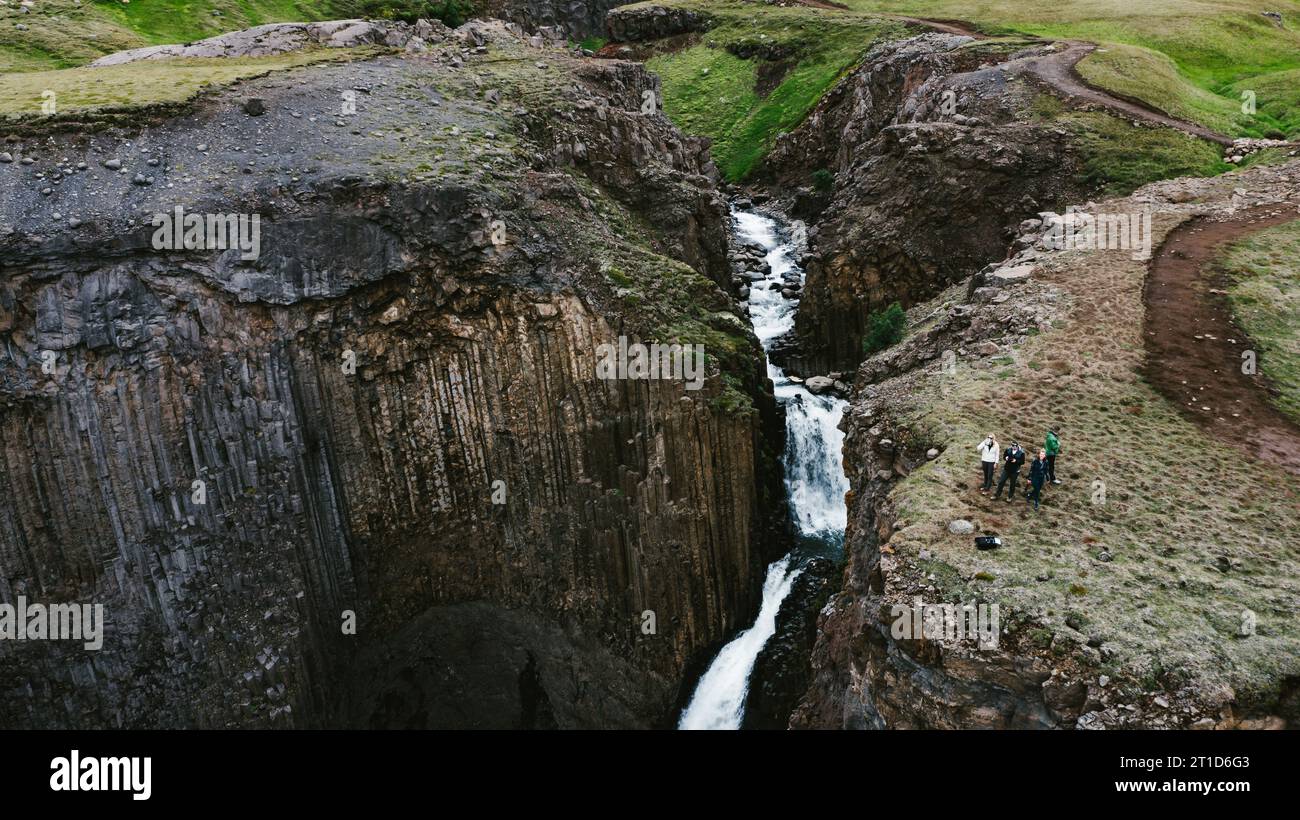 People on edge of basalt cliff with rivers and waterfalls Stock Photo ...