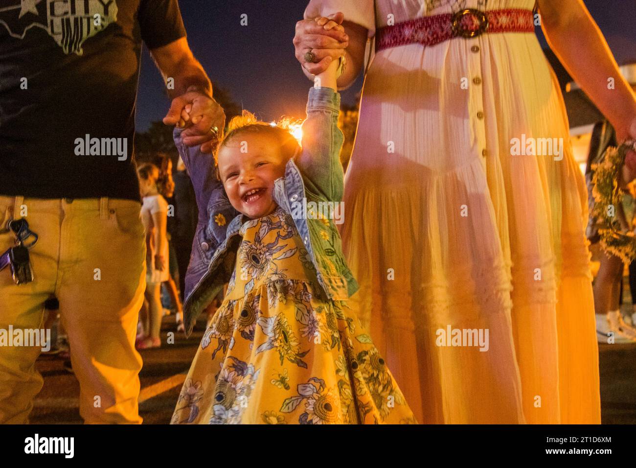 Toddler enjoys time with family at the fair Stock Photo - Alamy