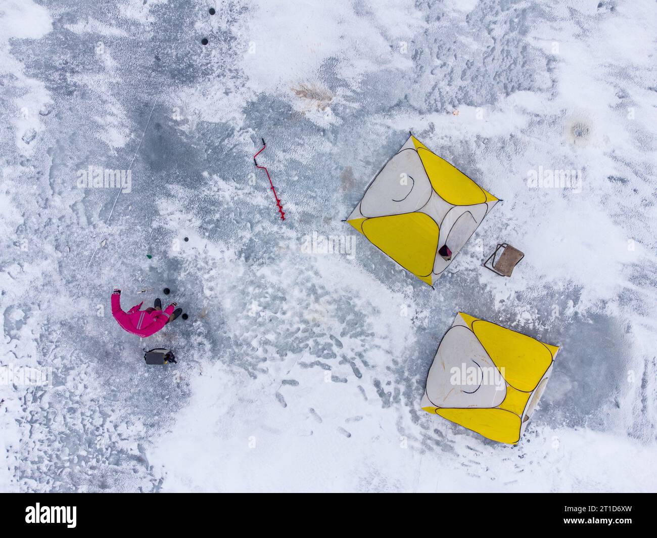 Winter fishing on a frozen lake. Colorful fishing tents mounted on ice ...