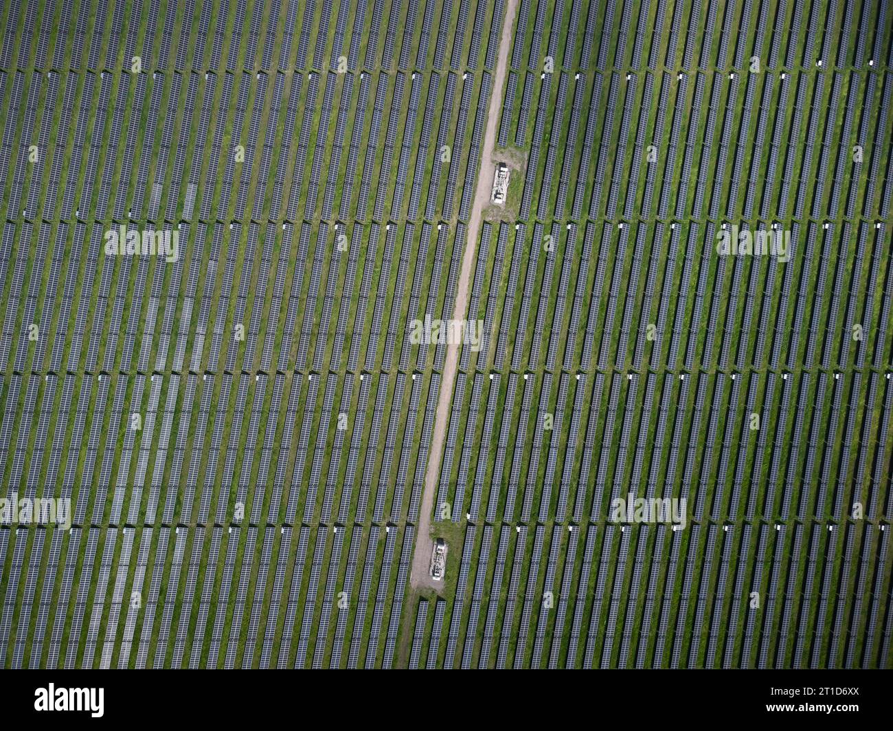 Aerial drone top view of solar power plant in green meadow at sunny day ...