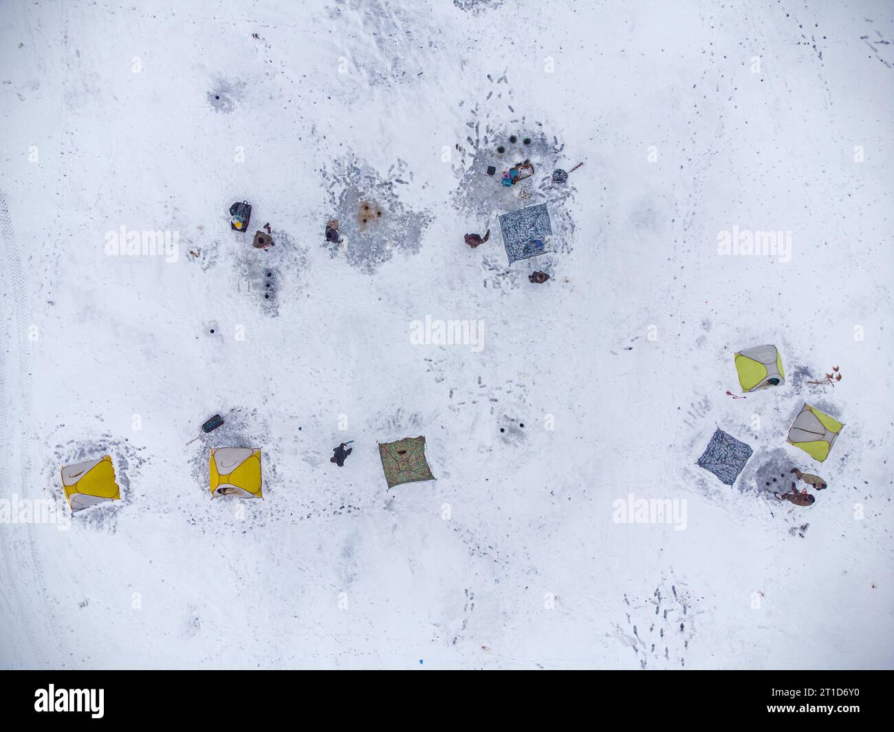 Winter fishing on a frozen lake. Colorful fishing tents mounted on ice ...