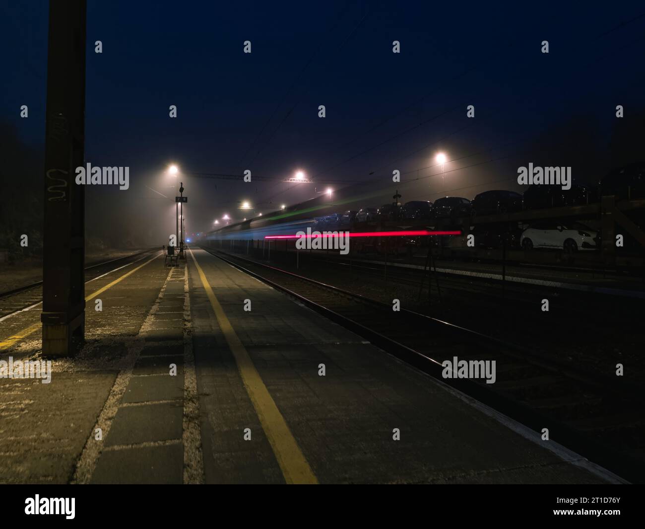 Empty railway station platform at night, long exposure with light ...