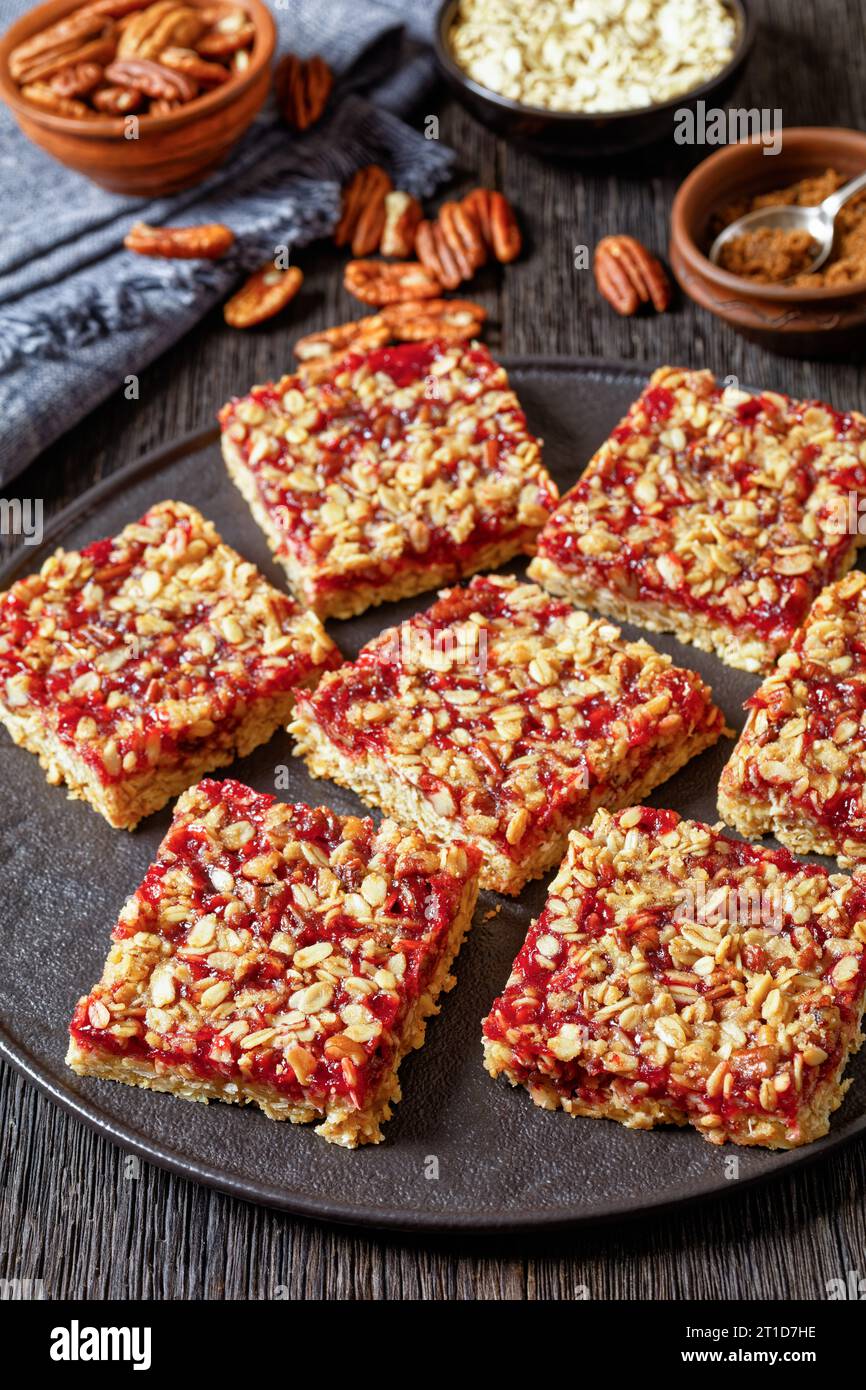 Berry Shortbread Bars with Rolled Oat and Nut Topping on black plate on ...