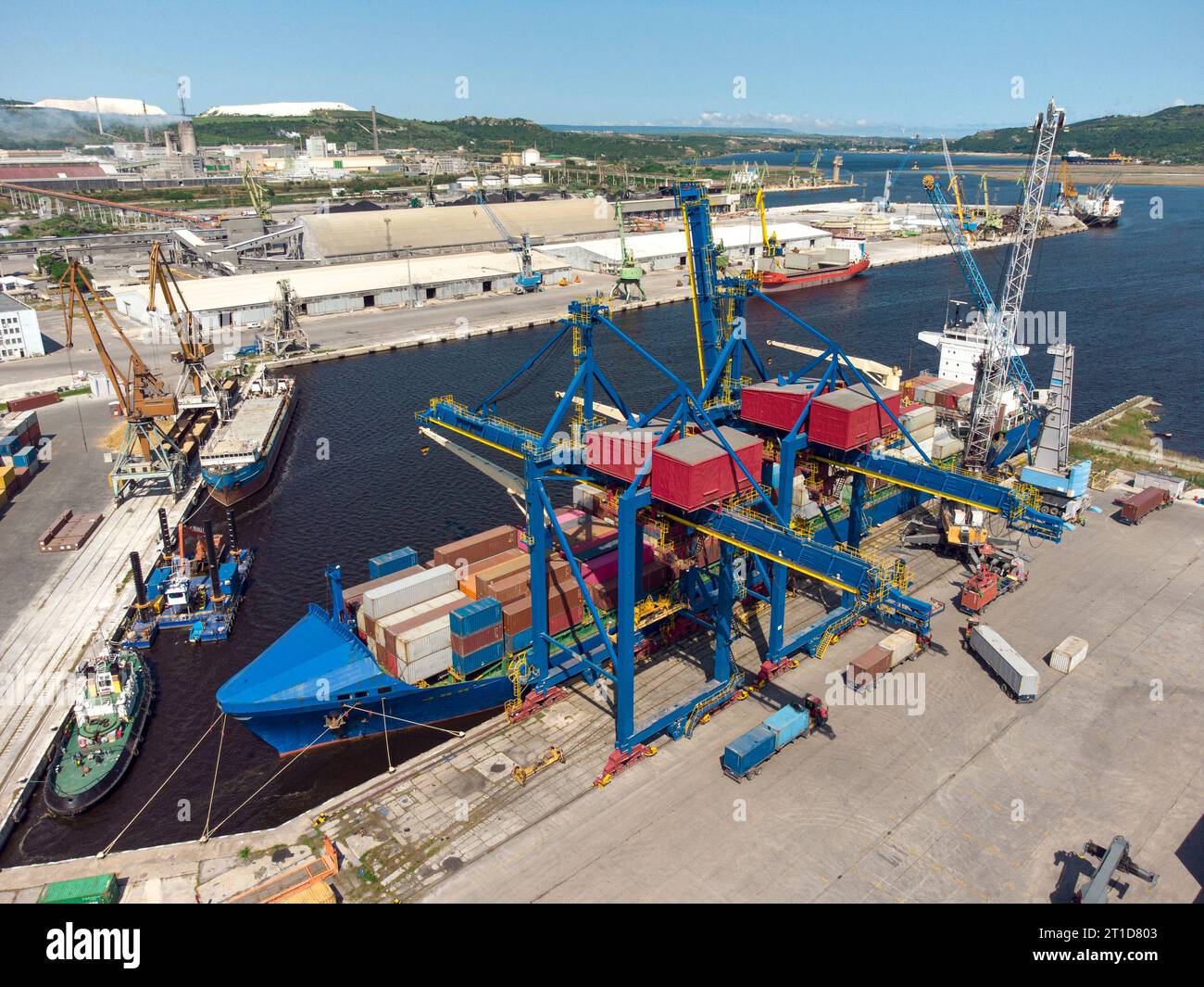 Aerial top view of a container ship being loaded and unloaded at ...