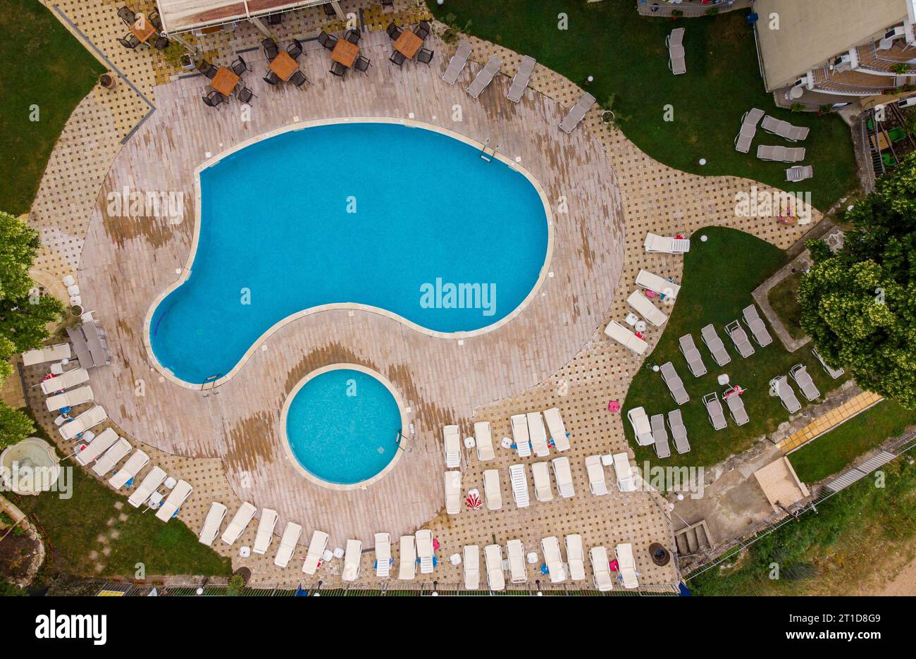Aerial top view of swimming pool with sunbeds at hotel Stock Photo - Alamy