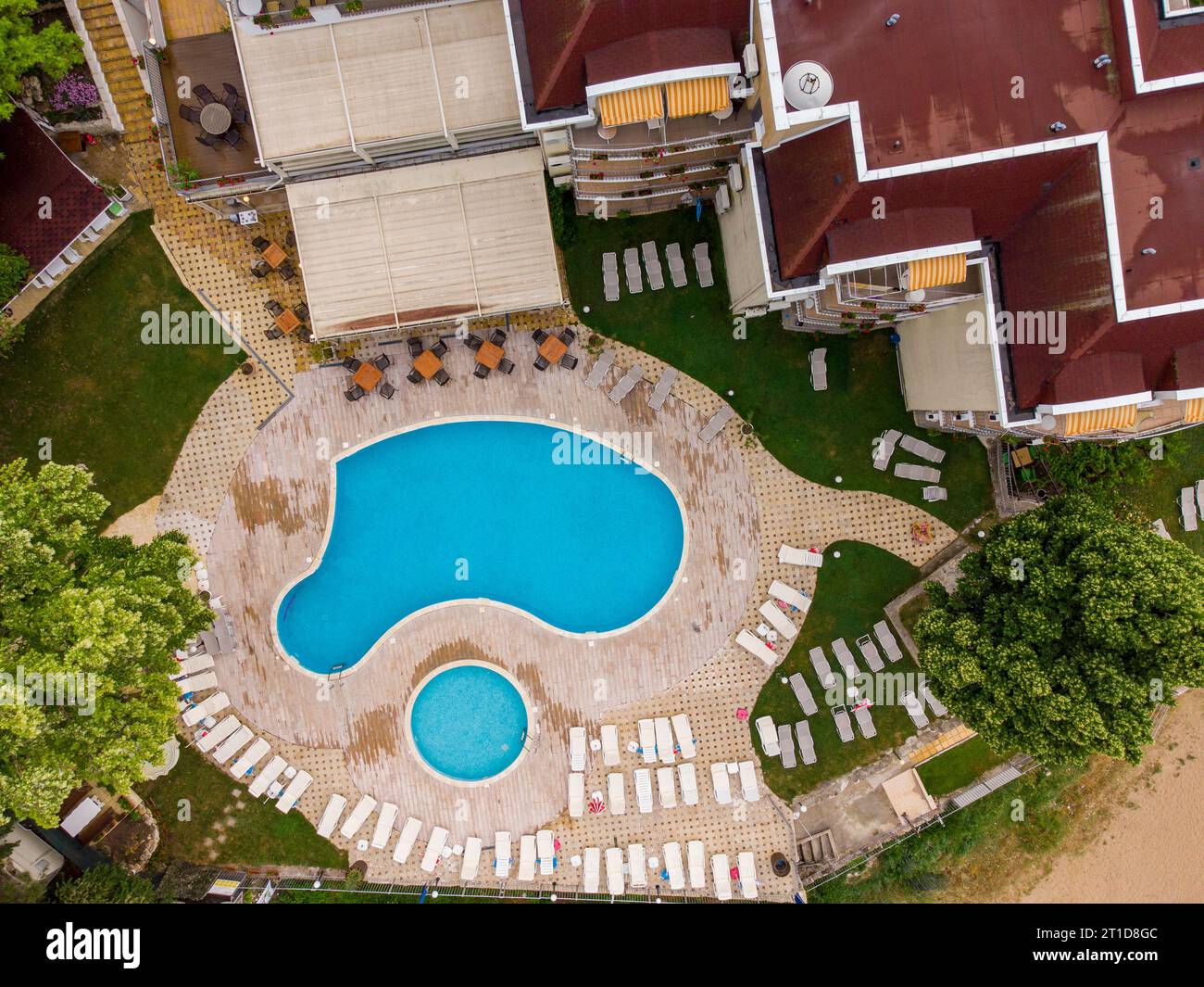 Aerial top view of swimming pool with sunbeds at hotel Stock Photo - Alamy