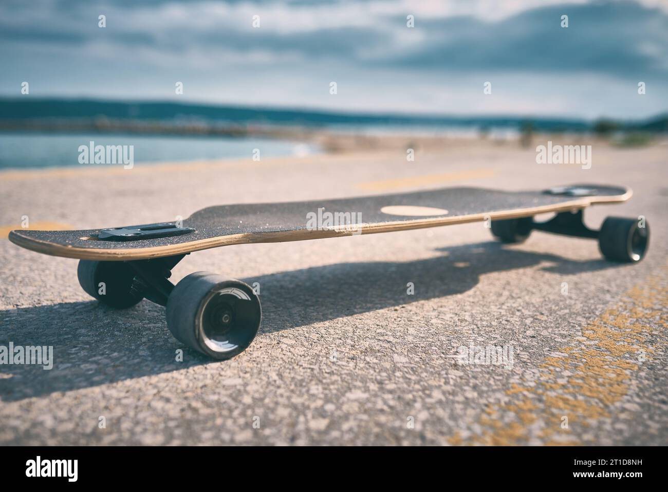 double kick cutaway longboard on asphalt against the background of the ...