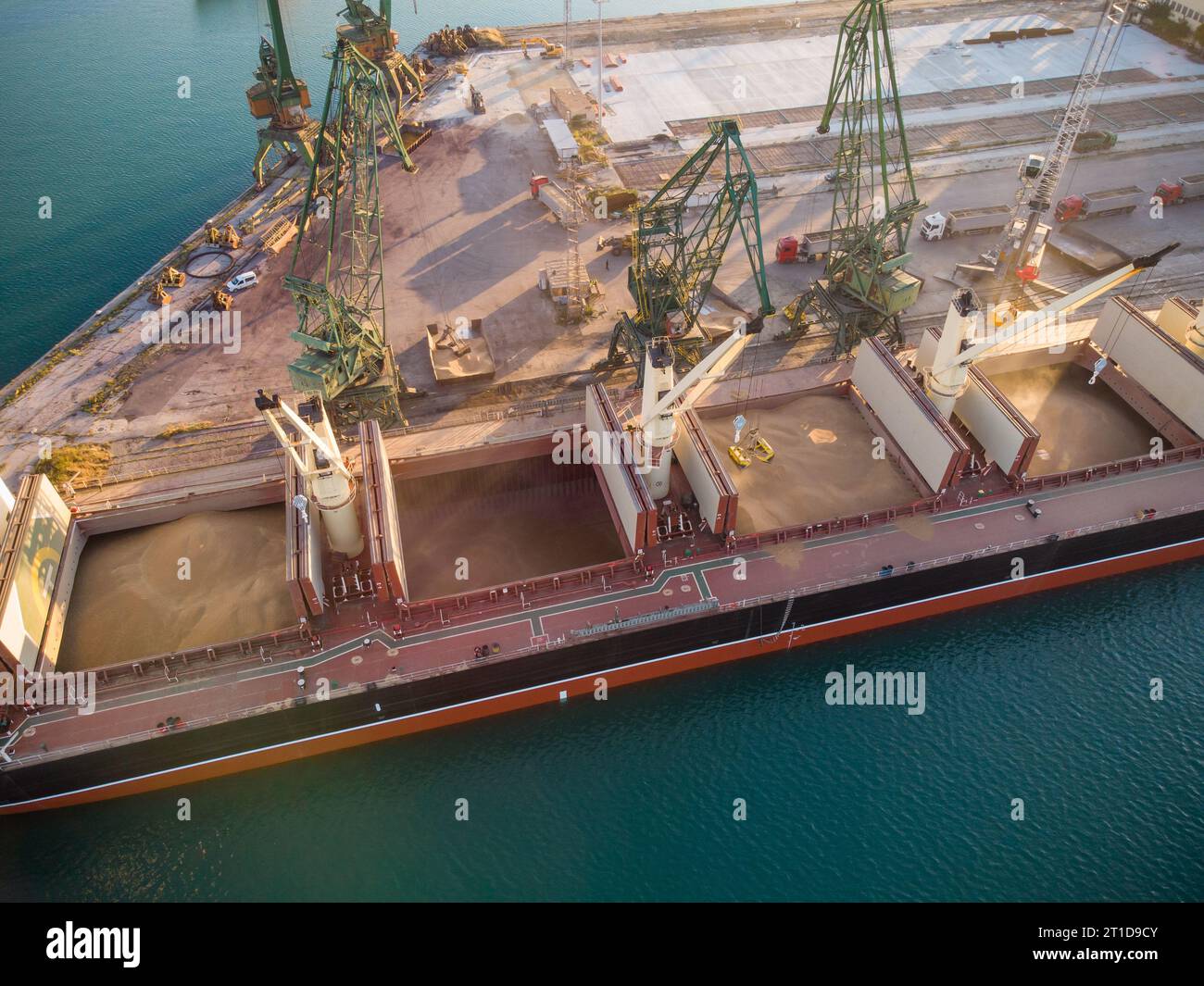 Aerial top view of big cargo ship bulk carrier is loaded with grain of ...