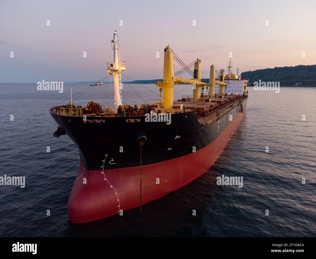 Large general cargo ship tanker bulk carrier, aerial top view at night ...