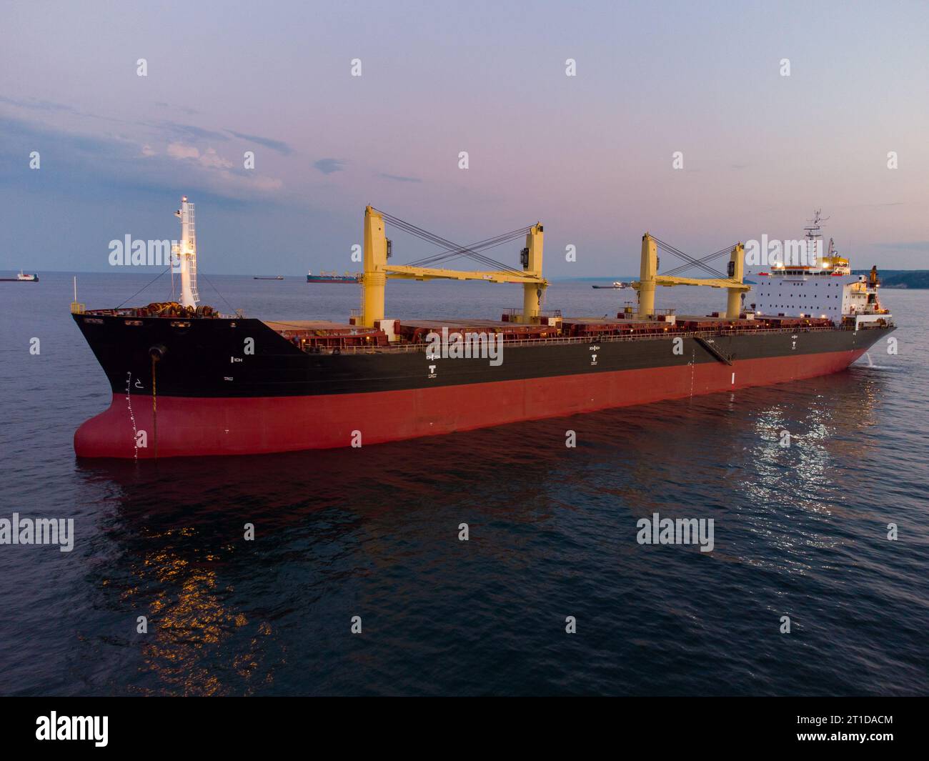 Large general cargo ship tanker bulk carrier, aerial top view at night ...