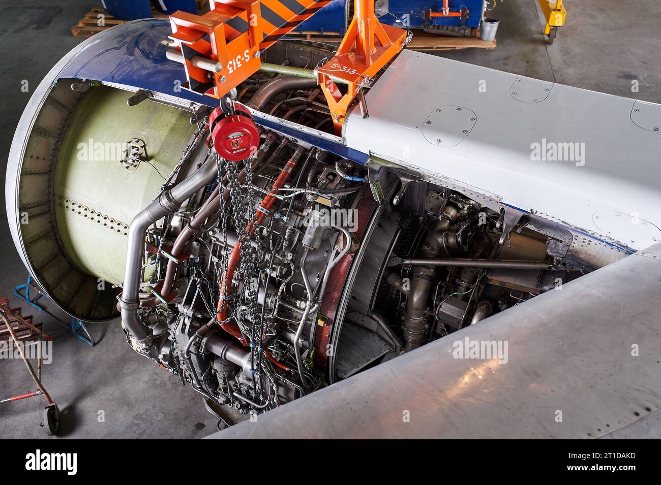 repairing the turbine engine of a passenger jet at a hangar. Open ...