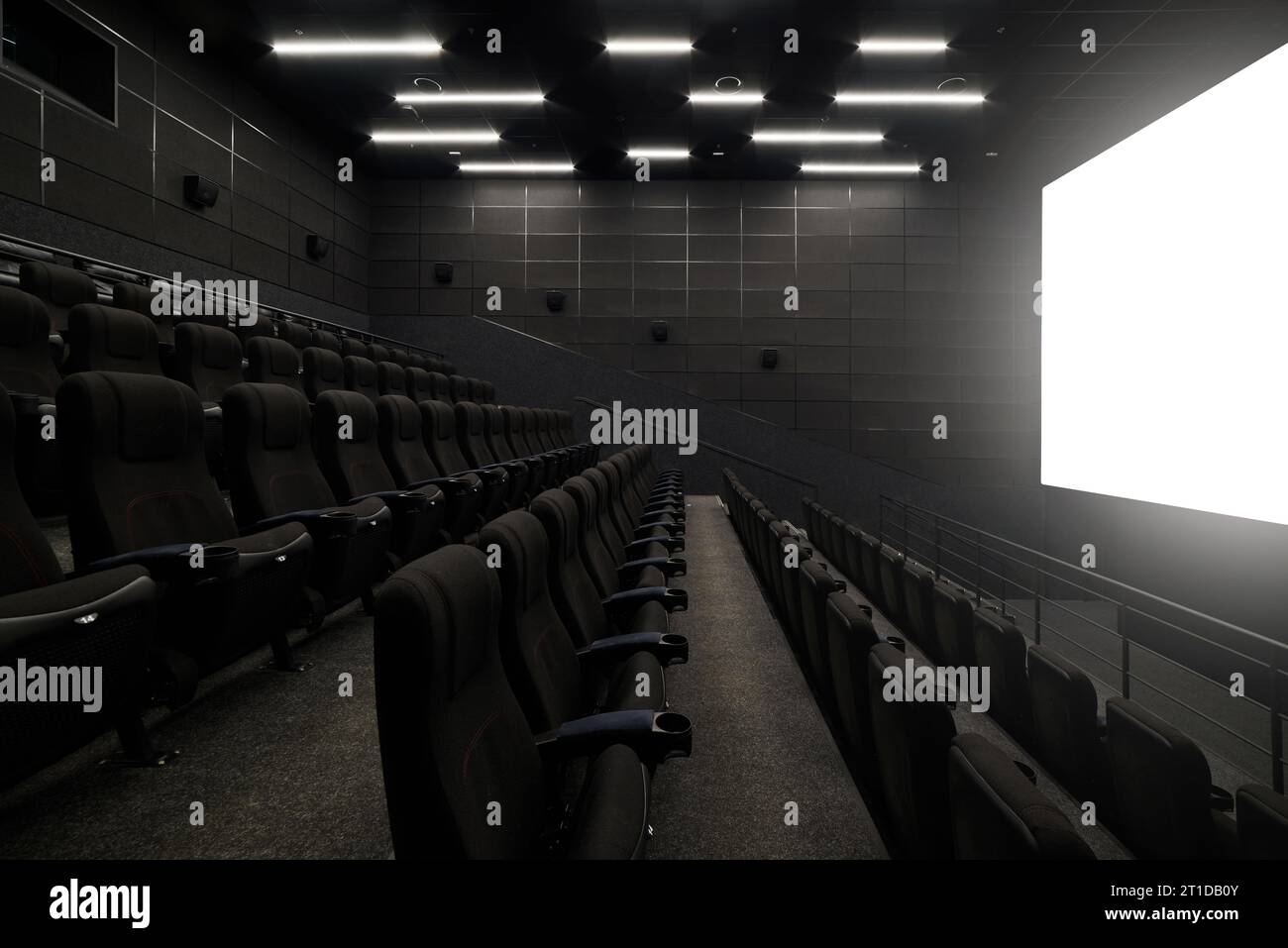 Empty cinema hall with black seats and walls. Movie theatre nobody ...