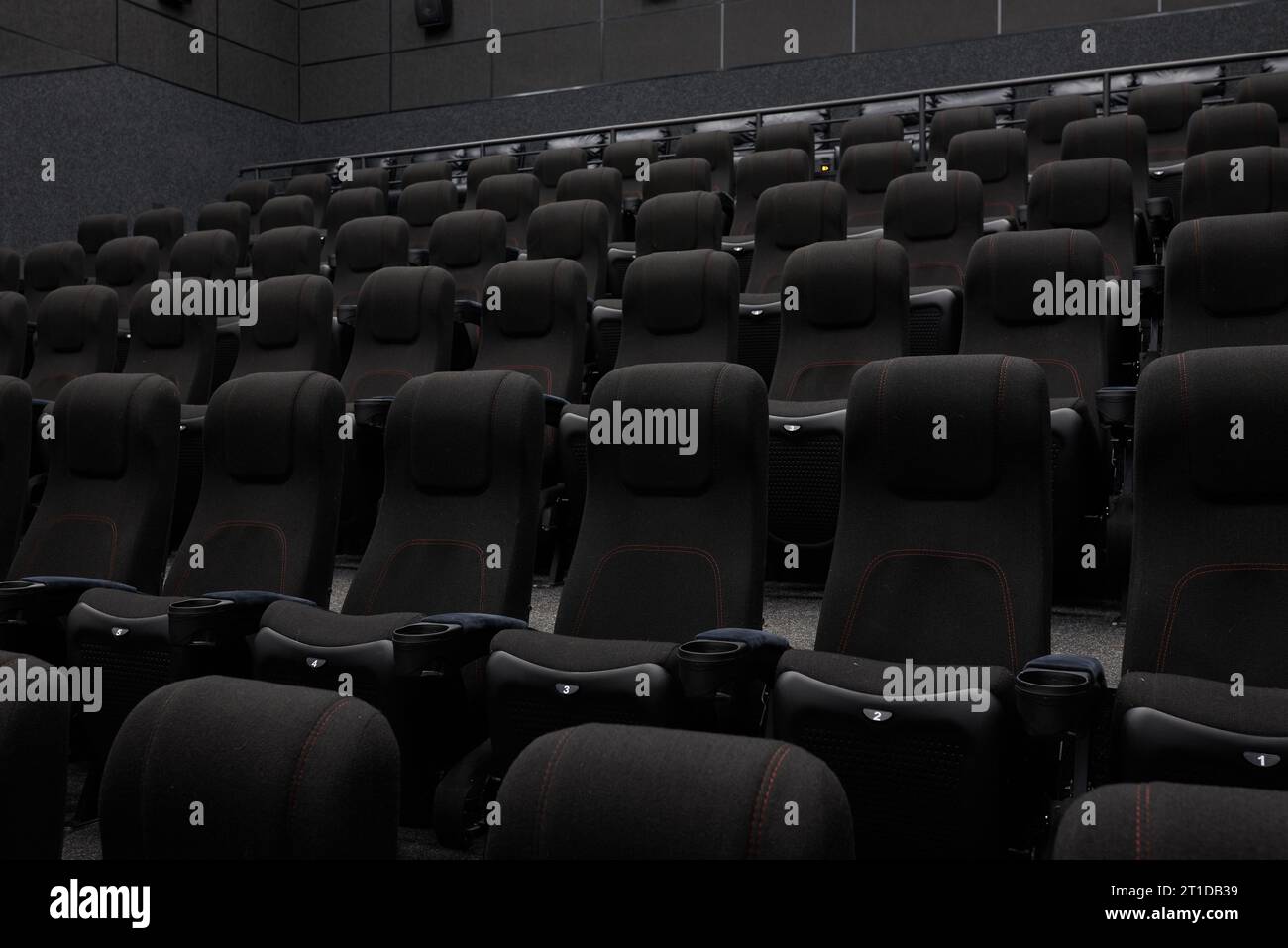 Empty cinema hall with black seats and walls. Movie theatre nobody ...