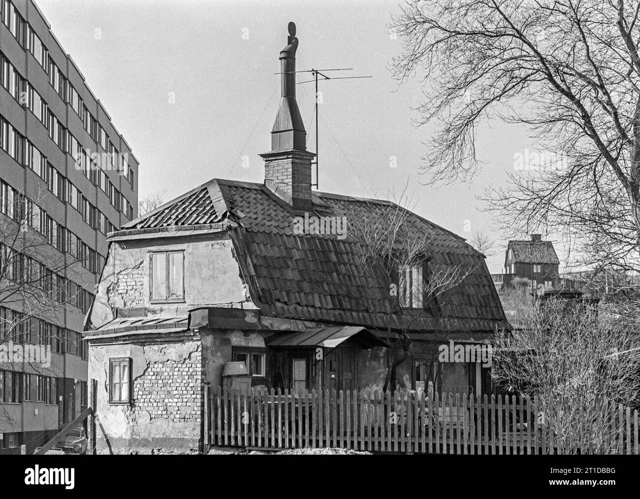 An eighteenth-century house in front of a modern eight-story building ...