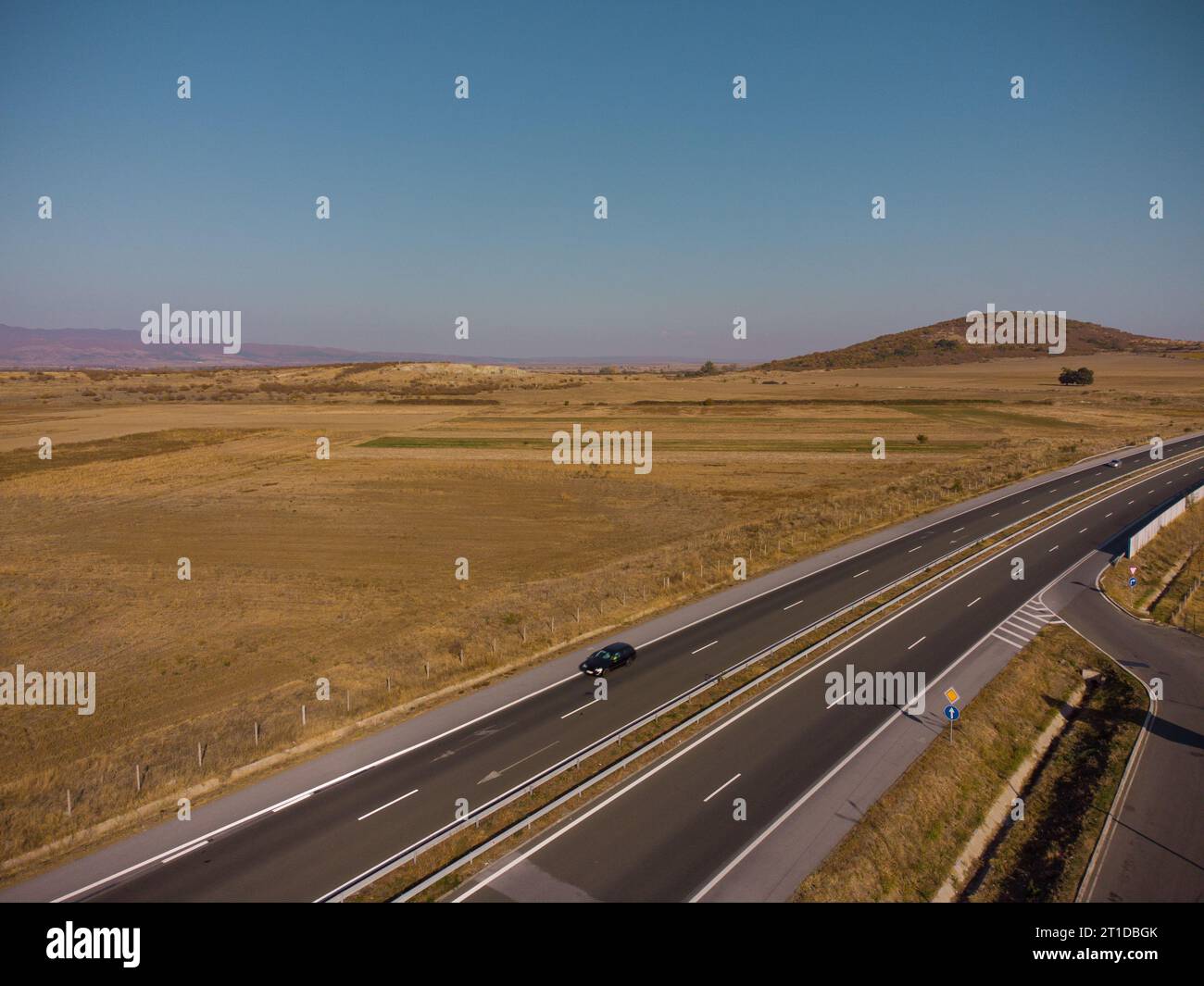 Aerial top view of highway road at sunset in autumn. Top view from ...