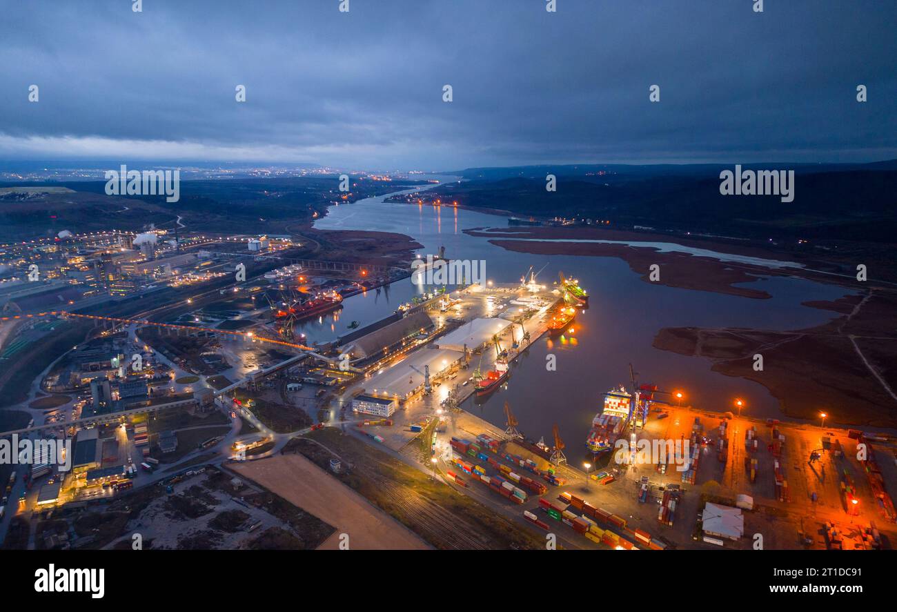 View of a heavily smoking factory at night, industrial area aerial ...