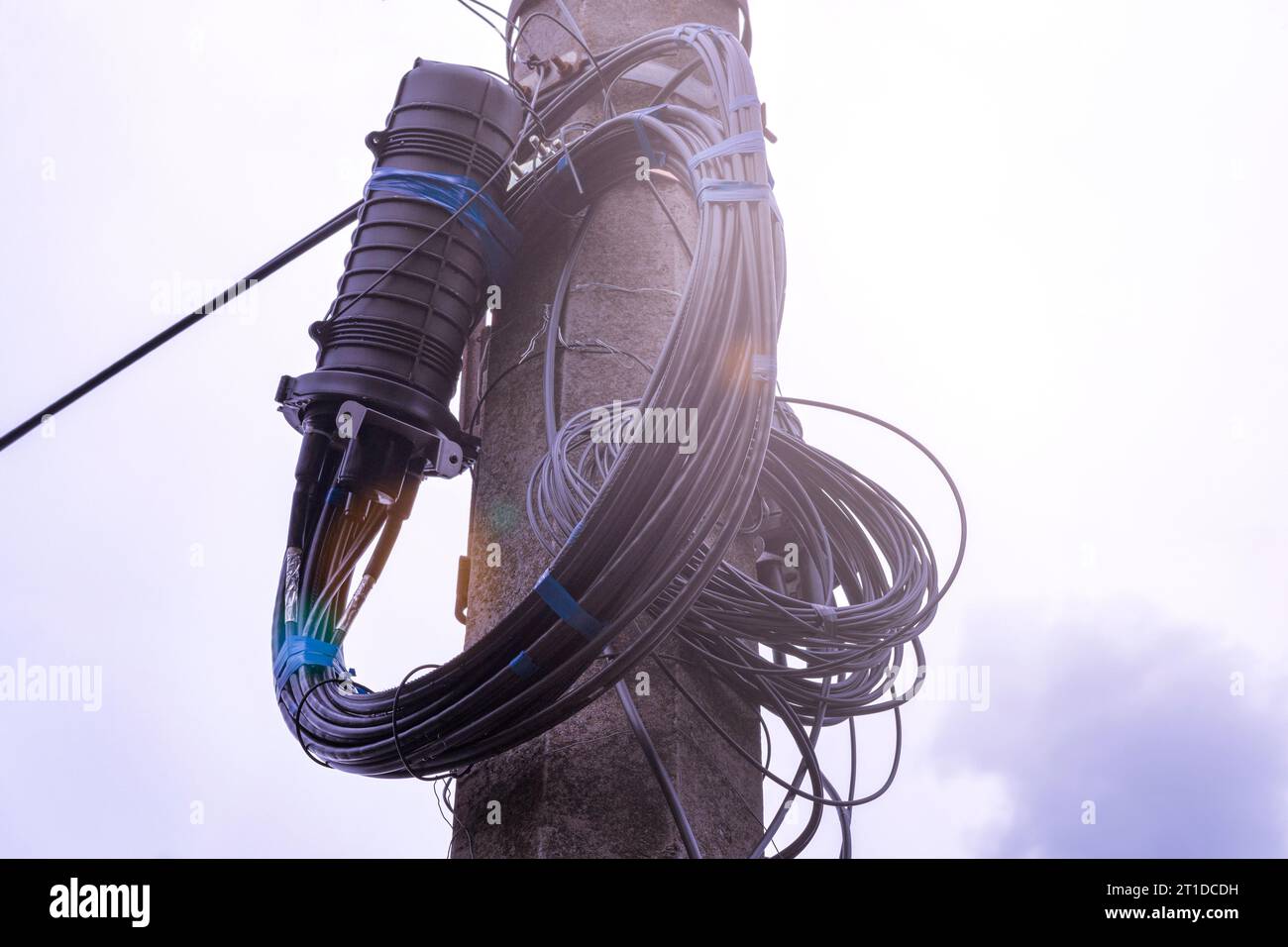 A fiber optic cable harness for communication weighs on a concrete ...