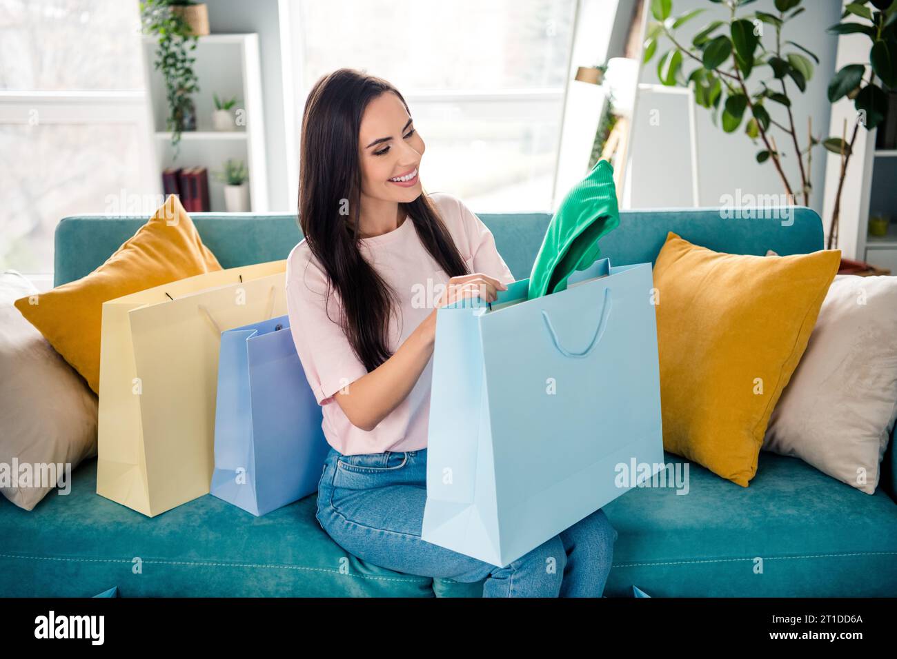 Photo of positive cheerful lady sitting comfy divan look delivery order ...