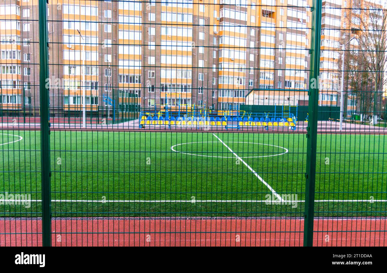 Football field with artificial lawn. Stadium and sports grounds near ...