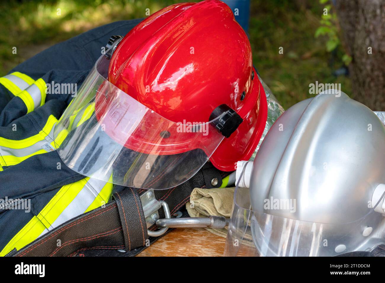 Firefighter uniform with red helmet. Close-up image of a red helmet of ...