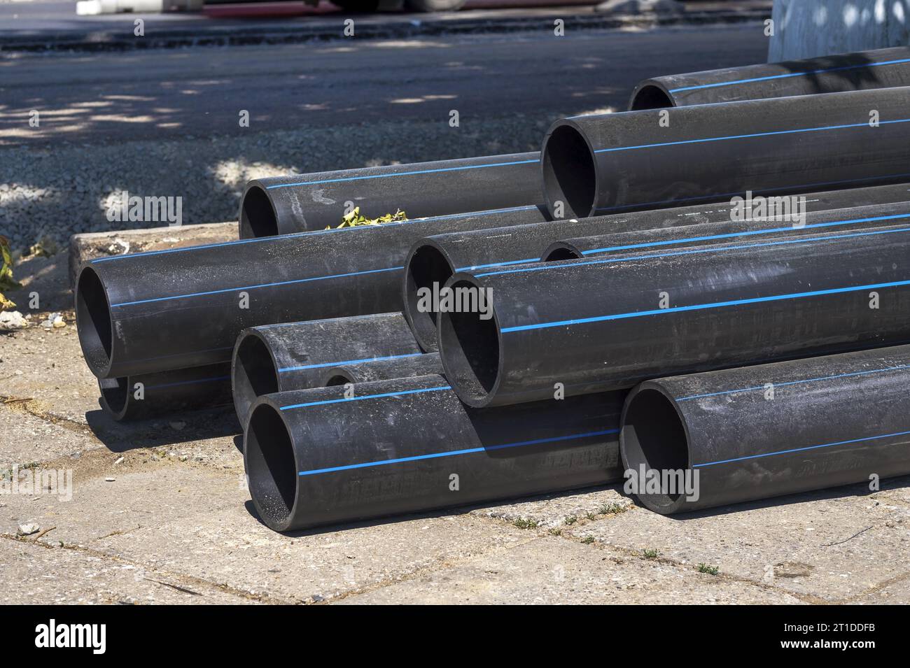 Plastic main black pipes. A heap of polyethylene pipes for a water ...