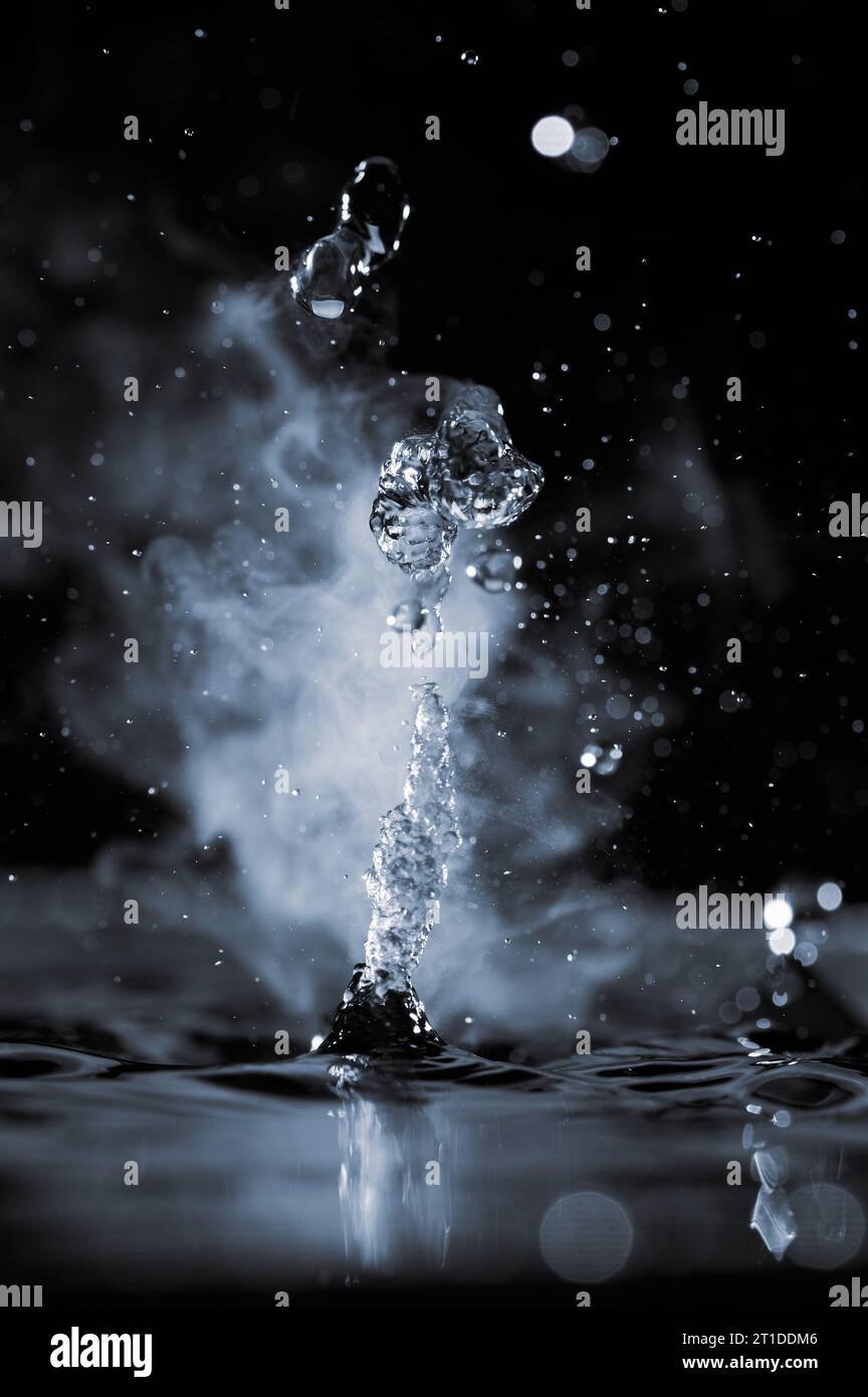 Boiling water splash with steam on black background close-up Stock ...
