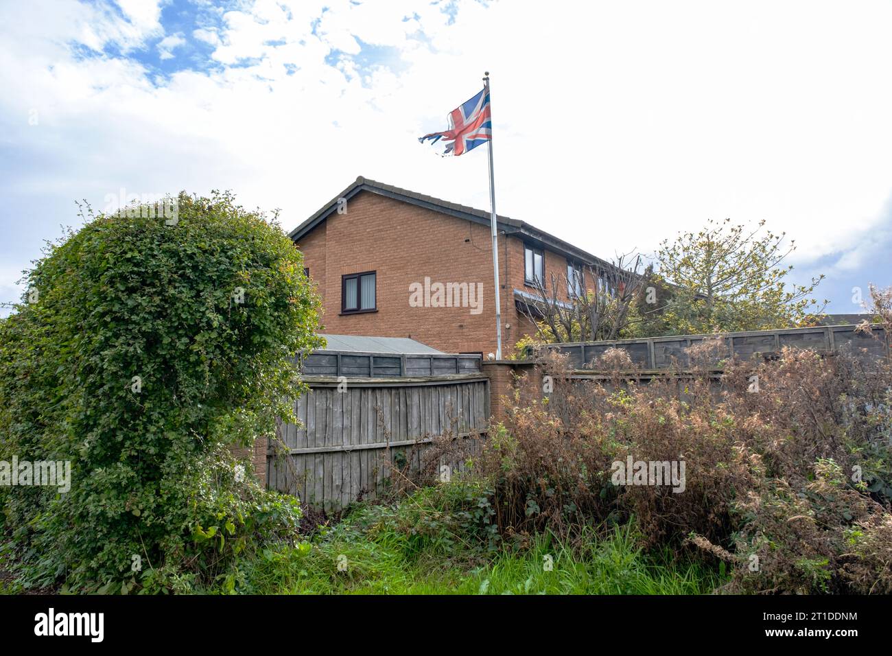Ripped Union Jack on housing estate UK Stock Photo - Alamy