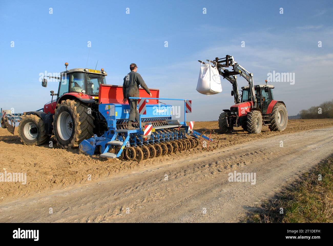 farmer loading his tractor's seed drill with faba bean seeds Stock ...