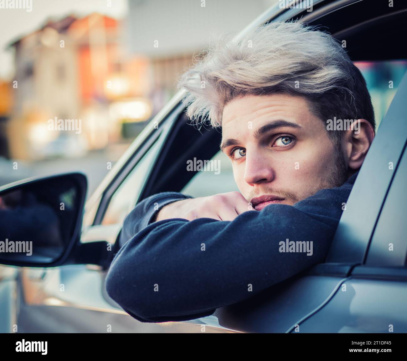 A man leaning his head out of a car window. Photo of a man leaning out ...