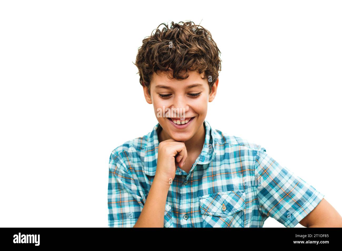 Joyful young boy in a blue plaid shirt chuckles, showcasing a ...