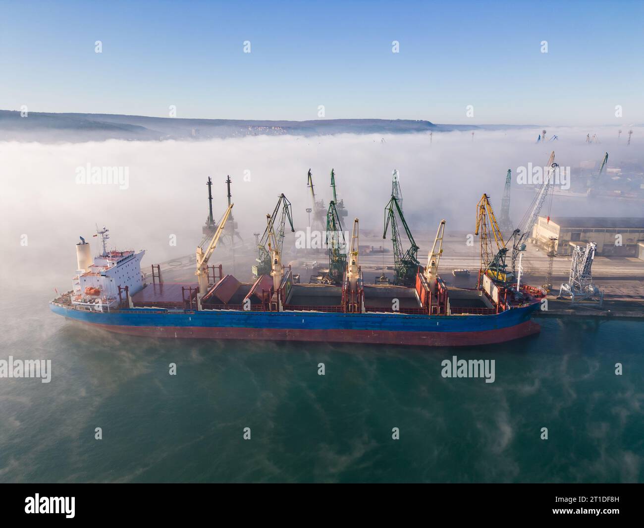 Aerial view of big cargo ship bulk carrier is loaded with grain of ...
