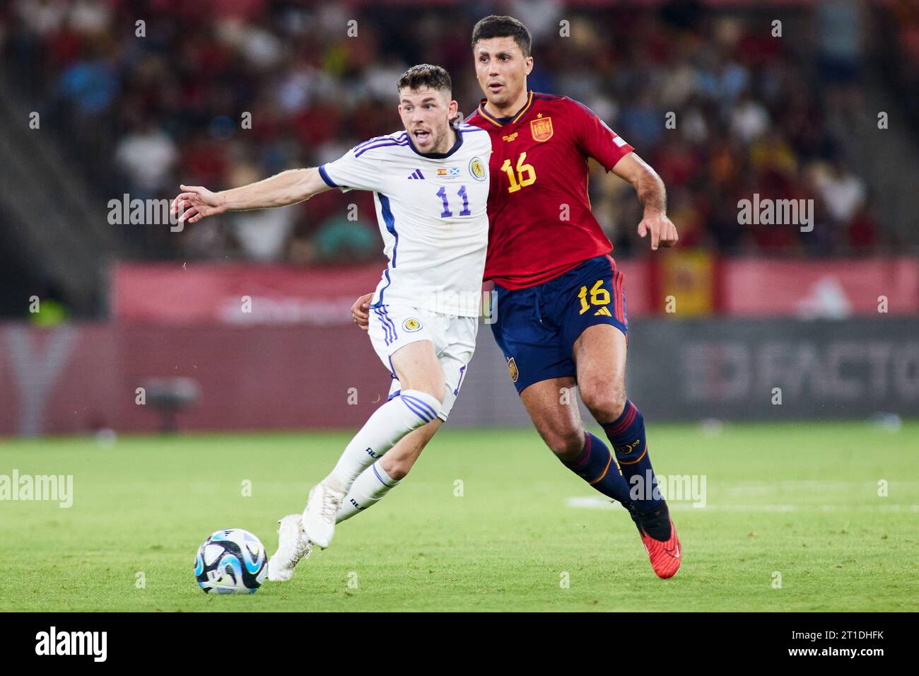 Rodrigo 'Rodri' Hernandez of Spain and Ryan Christie of Scotland during ...