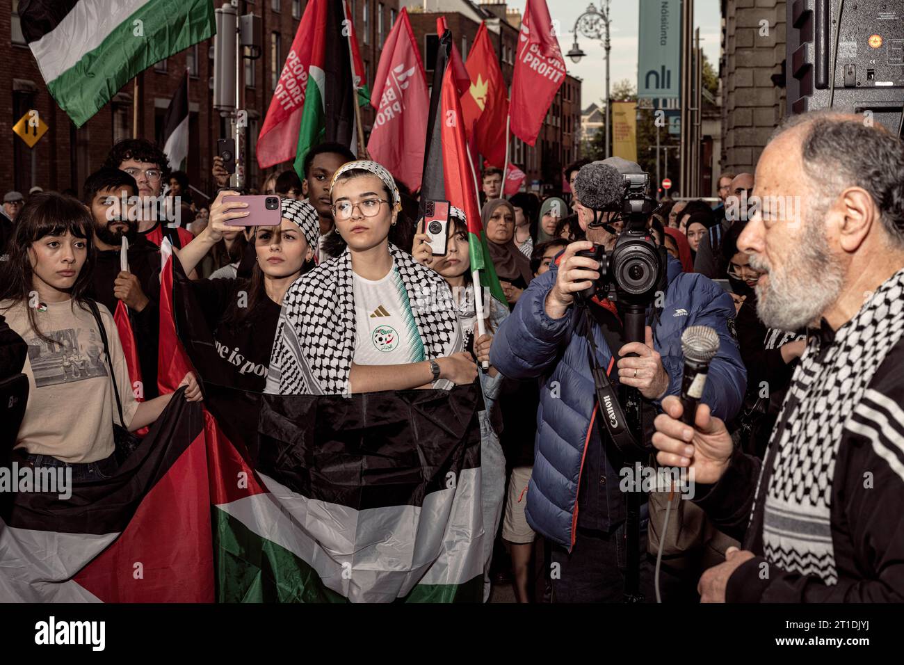 Members of the Palestinian community hold flags during the ...