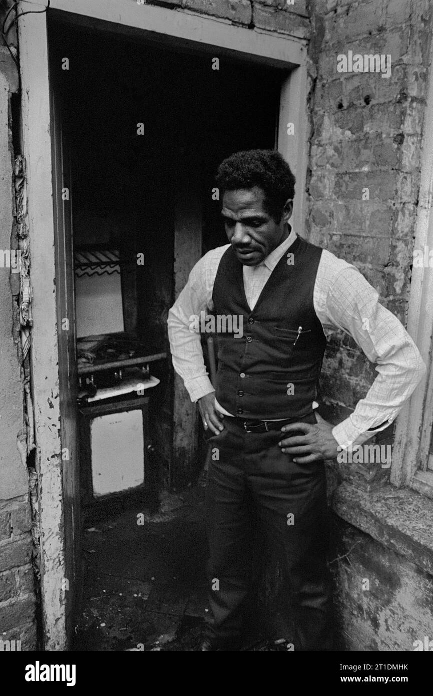 Black man stood in the scullery doorway of his Victorian terraced house ...