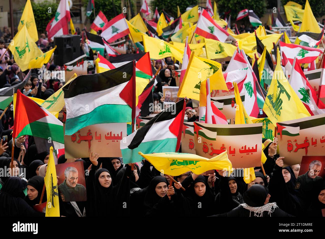 Hezbollah supporters wave Lebanese, Palestinian and their group flags ...