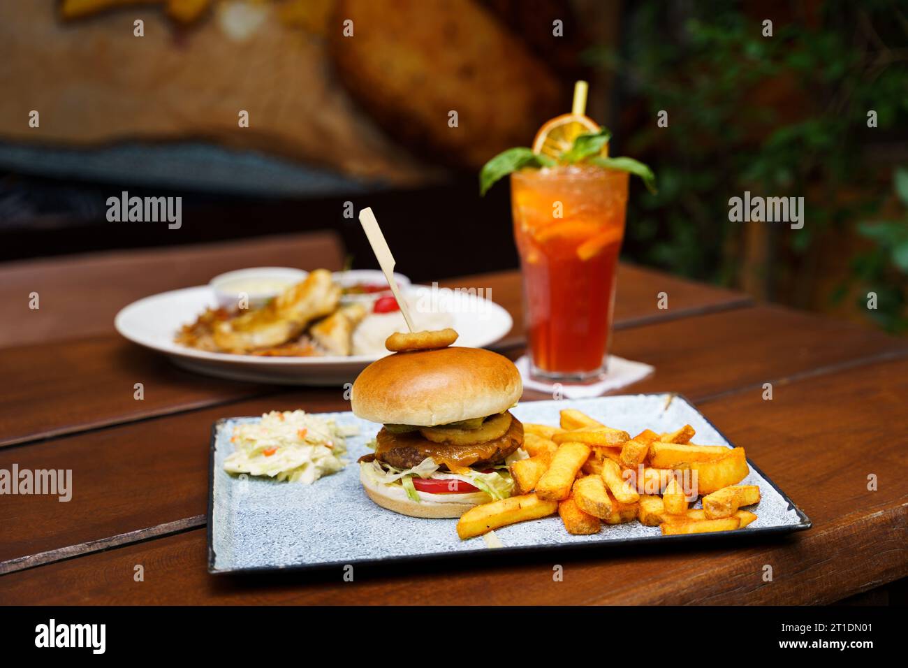 Hamburger with potatoes, onion ring, coleslaw and lemonade Stock Photo - Alamy