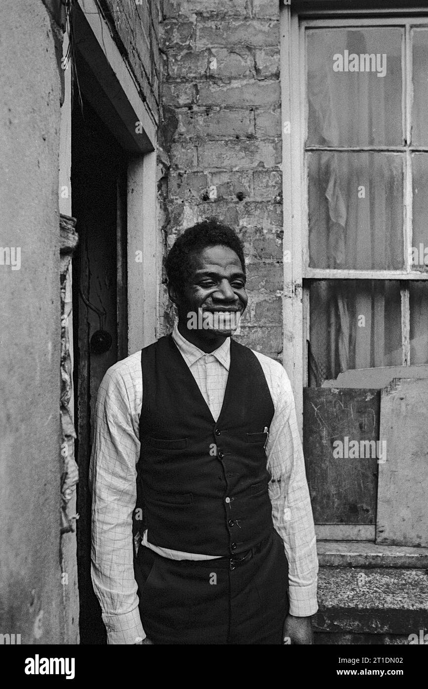 Black man stood in the scullery doorway of his Victorian terraced house ...