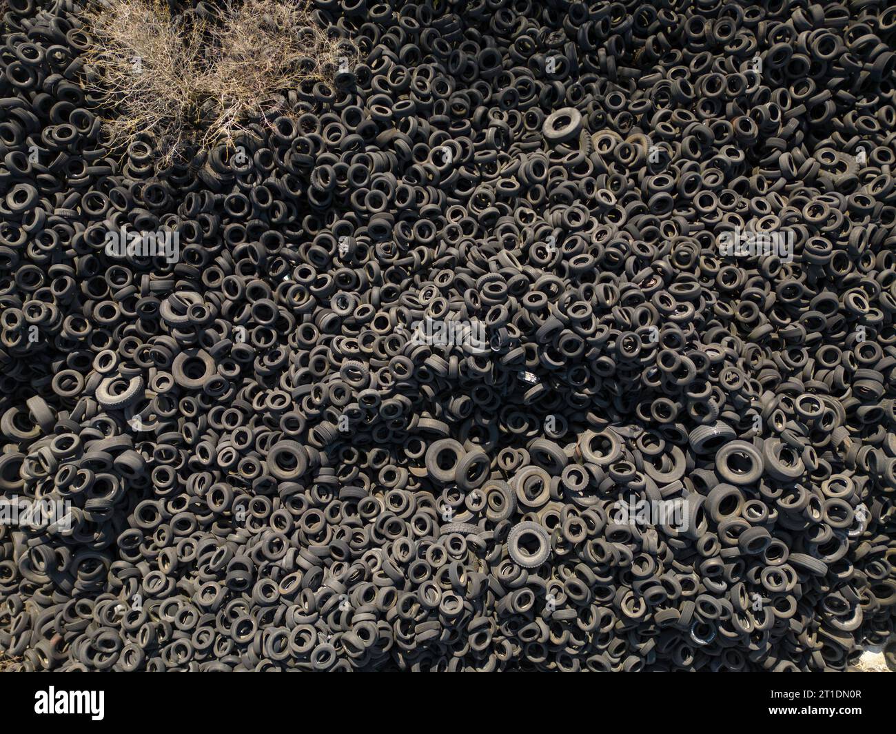 top-down view of a massive dump of car tires. The sea of discarded ...