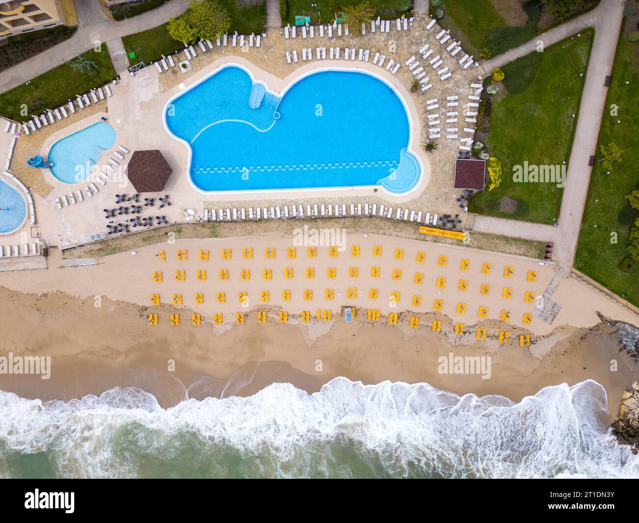 A breathtaking aerial view of a luxurious hotel with a seafront pool ...