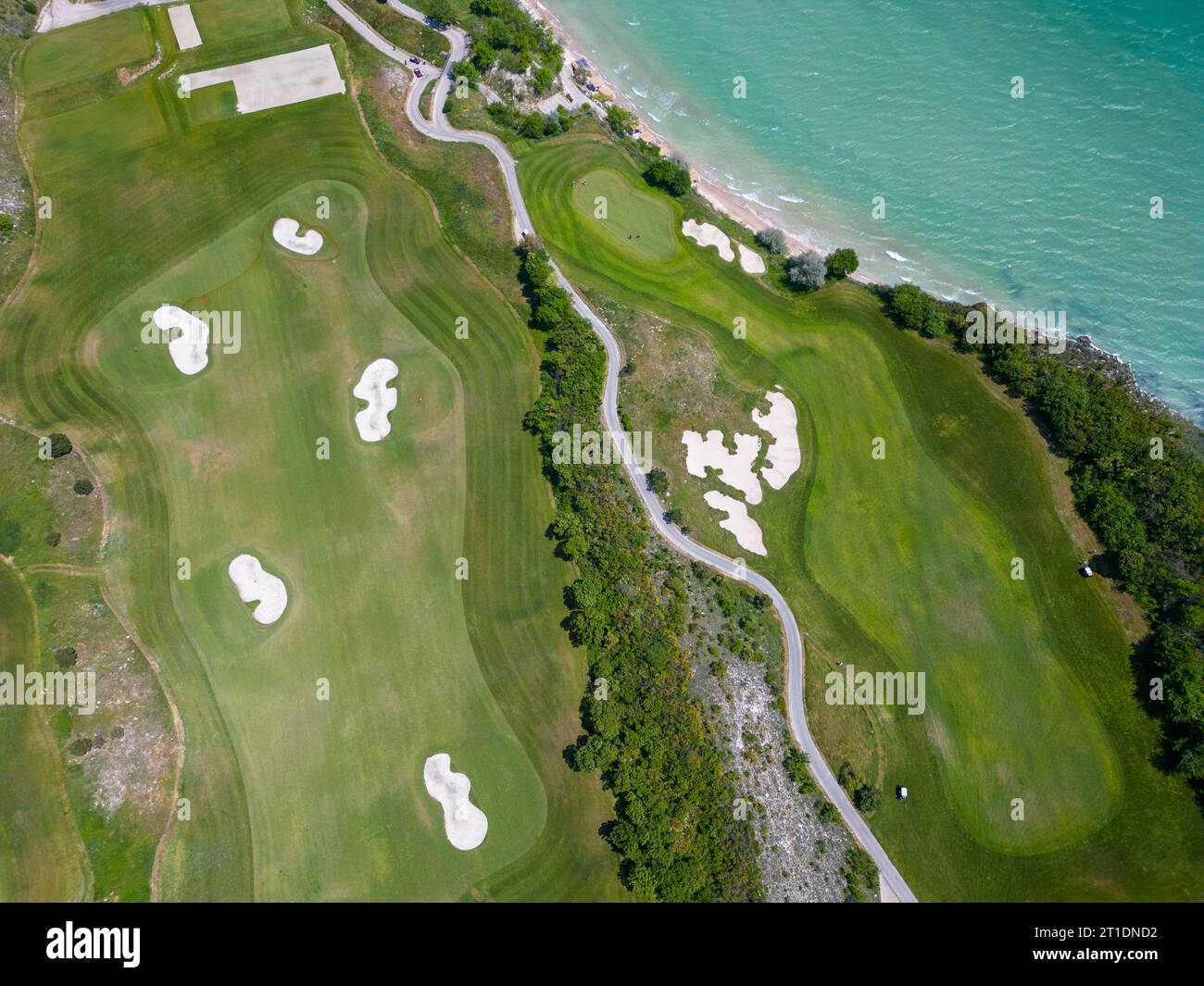 Aerial view of the golf course stretches out beneath, its lush green ...