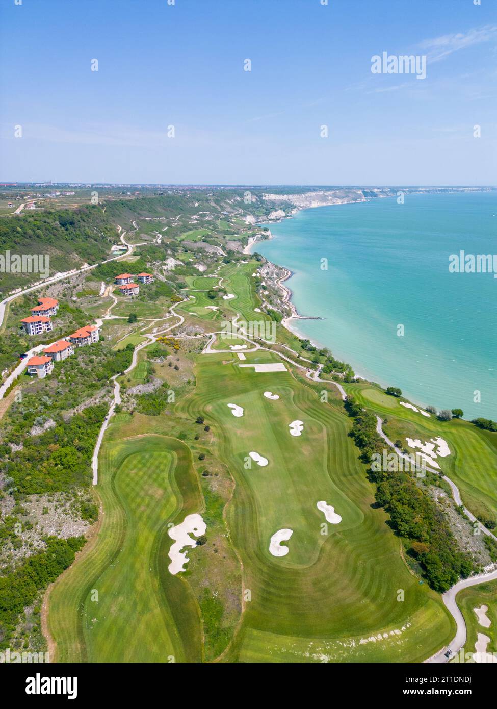 Aerial view of the golf course stretches out beneath, its lush green ...