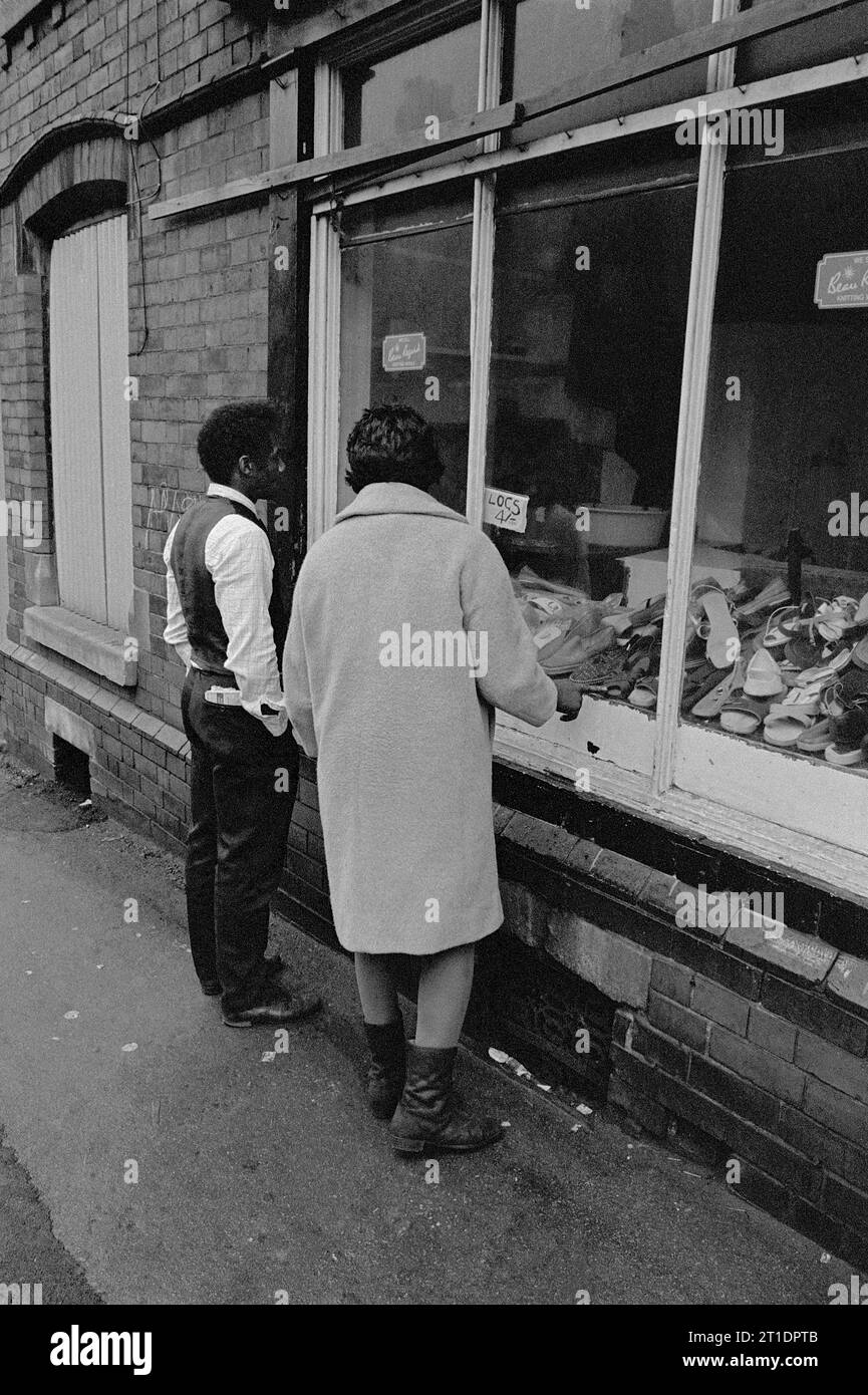 Black man and woman outside a corner shop on Pym Street, Flewitt Street ...