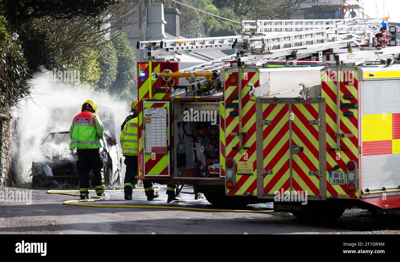 Fire Brigade Ireland putting out car fire Stock Photo - Alamy